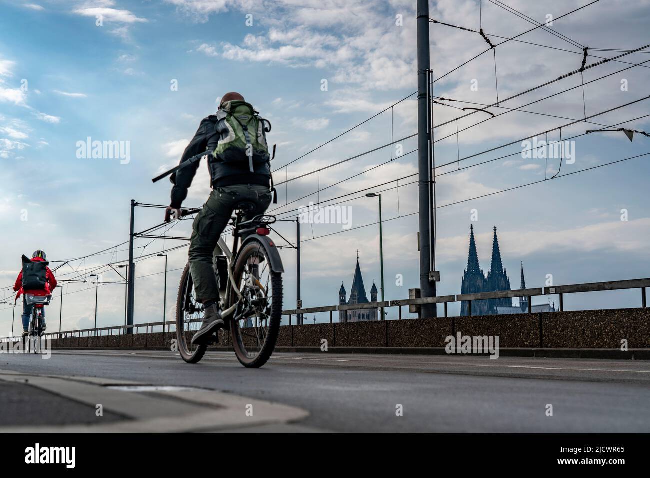 Cycling in the big city, cyclists on the Deutzer Bridge in Cologne ...