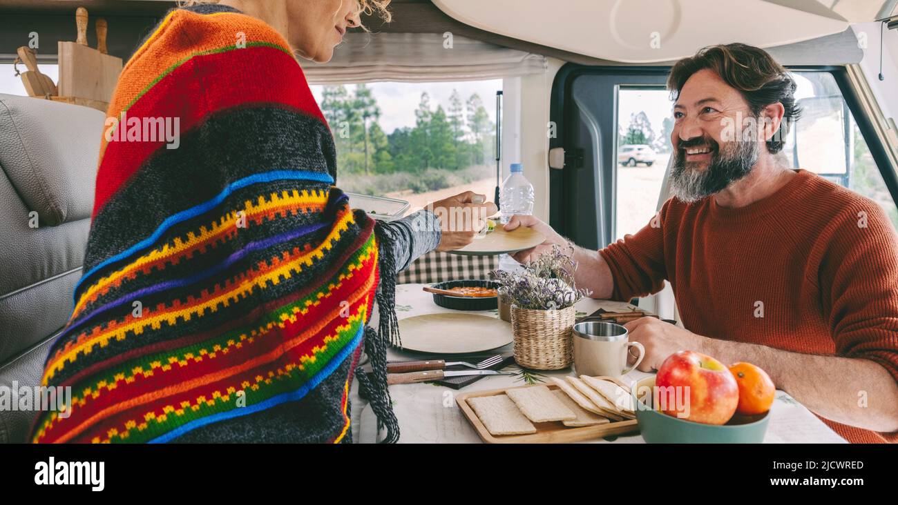 People in travel vacation leisure inside a camper van enjoying lunch ...