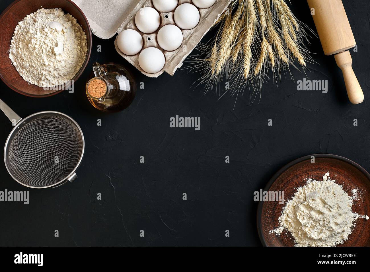 Pasta cooking ingredients on black kitchen table. Top view with space ...