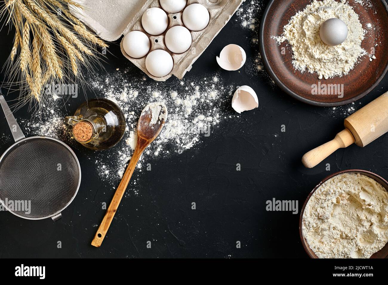 Pasta cooking ingredients on black kitchen table. Top view with space ...