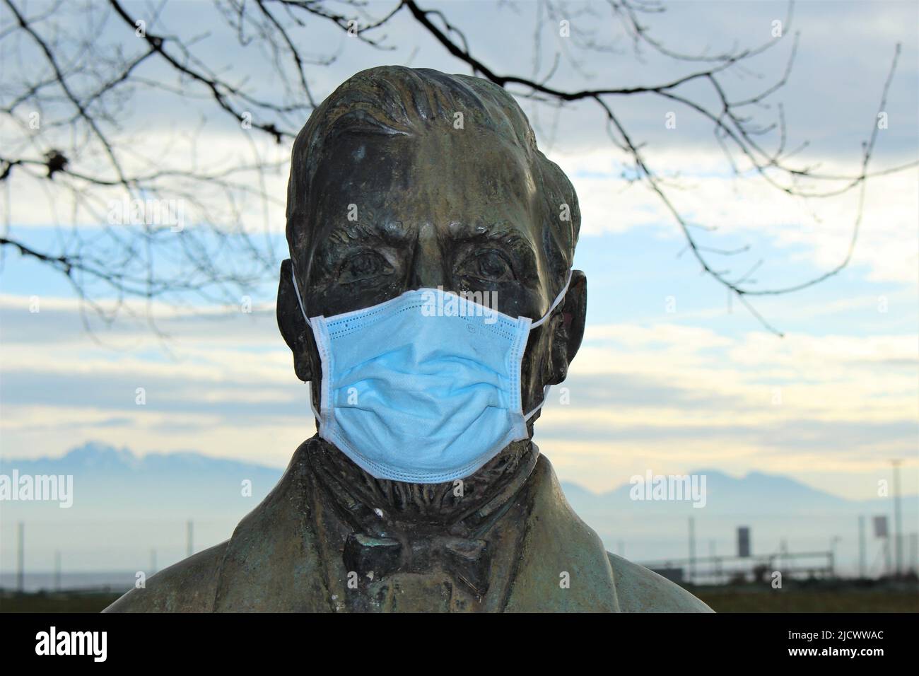 Statue of a man with a blue medical covid mask over his face (Parc de ...