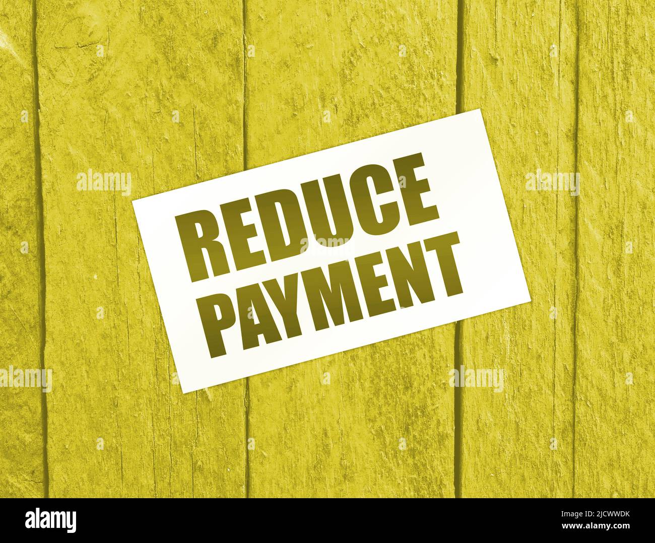 Reduce payment text on card on wooden background. business concept ...