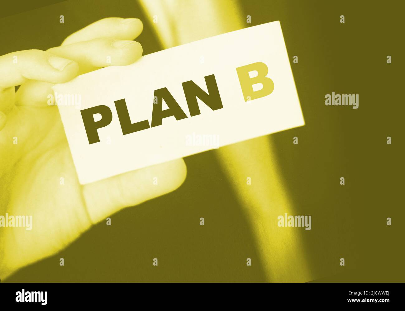 Plan B words on card in hand of businessman wearing suit and tie ...