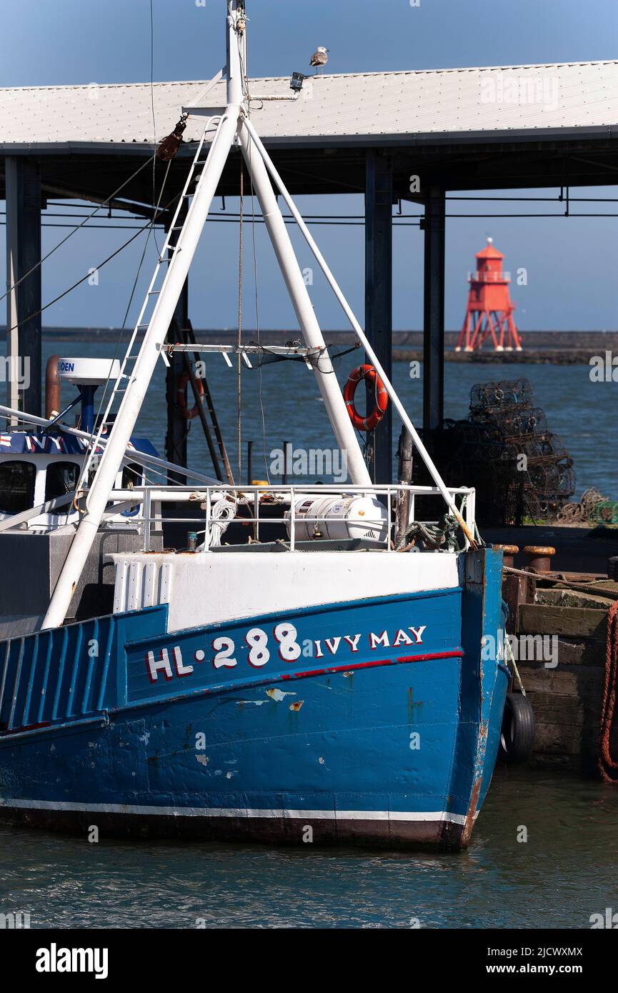 Fishing boats at North Shields Fish Quay with view of Herd Groyne ...