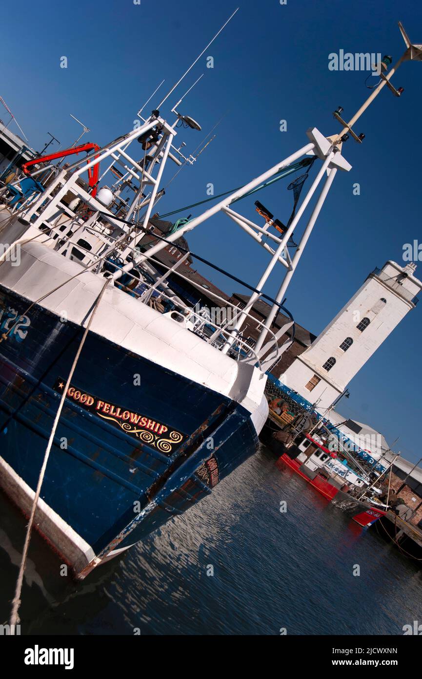 Fishing boats and Low Lights lighthouse at North Shields Fish Quay ...