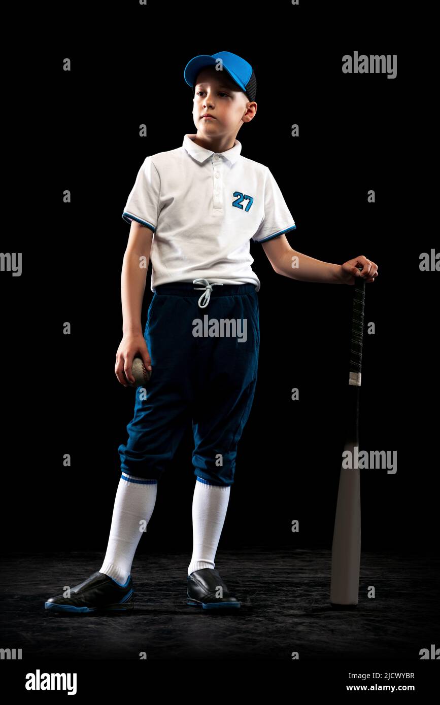 Full-length portrait of kid, beginner baseball player in sports uniform ...