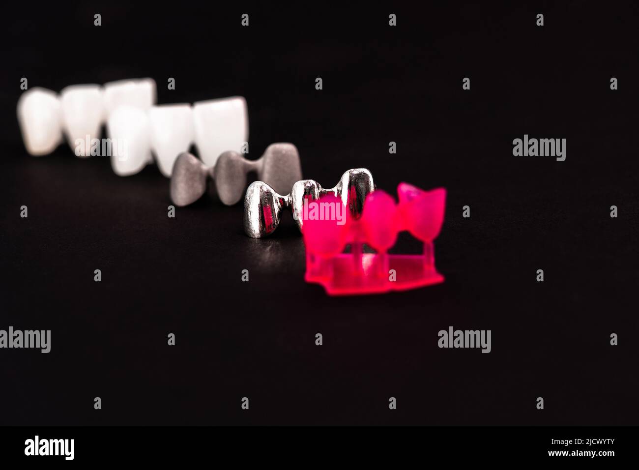 Teeth implant and crown installation process parts isolated on a black ...