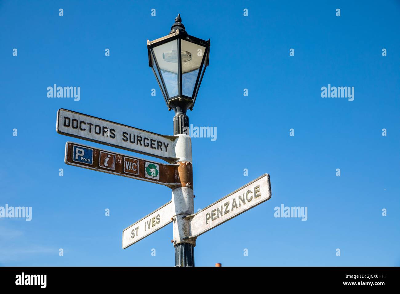 Signs on a lamp post in St Just, Cornwall,uk Stock Photo - Alamy