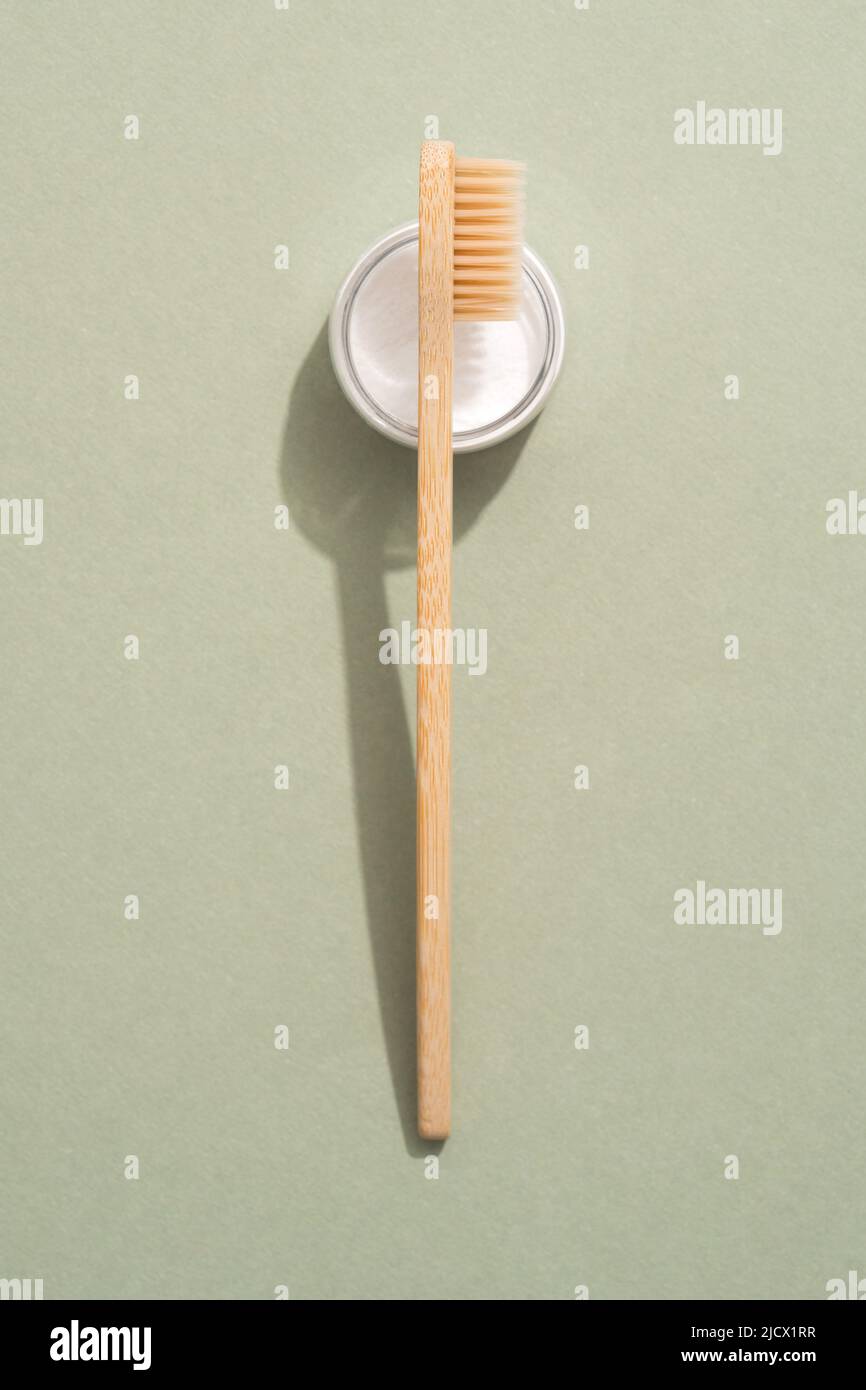 Vertical image of wooden bamboo toothbrush with mineral toothpowder ...