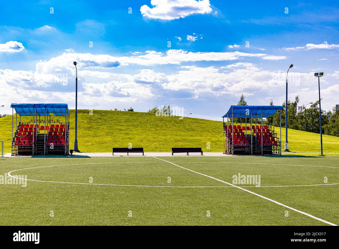 empty stand standing on the football field in summer. High quality ...