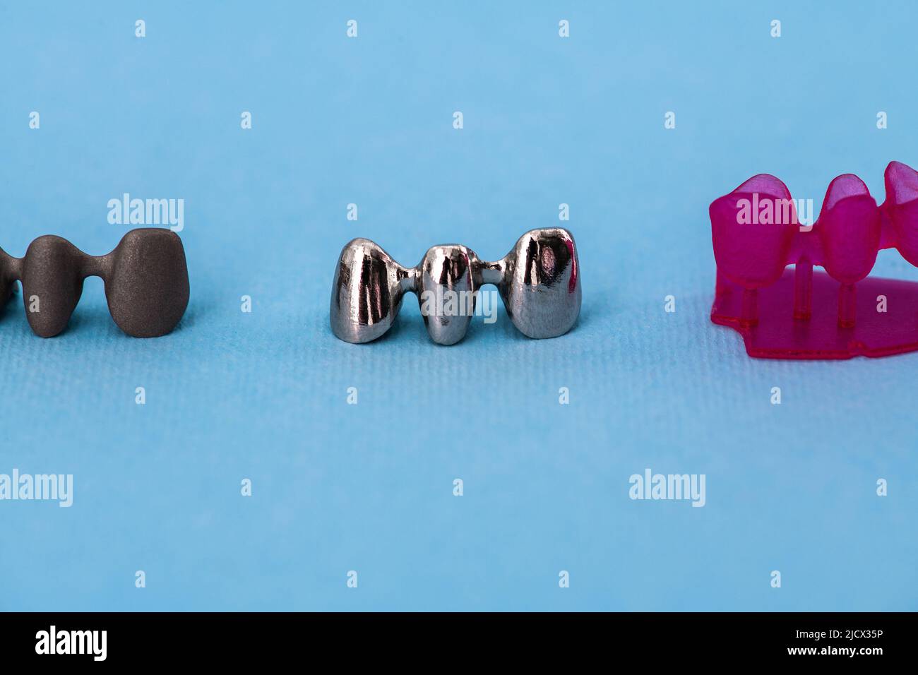 Teeth implant and crown installation process parts isolated on a blue ...