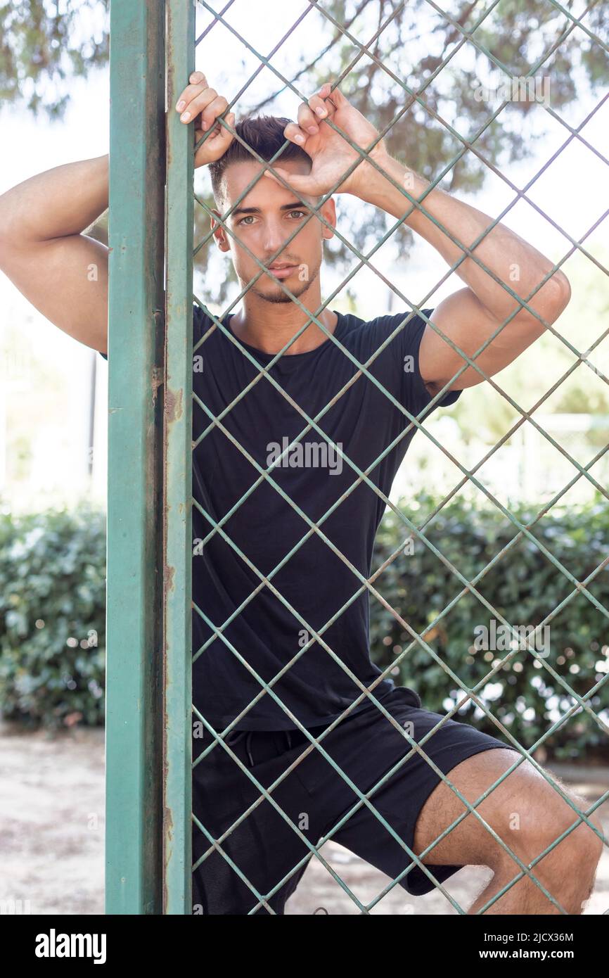 Portrait of a handsome young guy sportsman, wearing sports clothes ...
