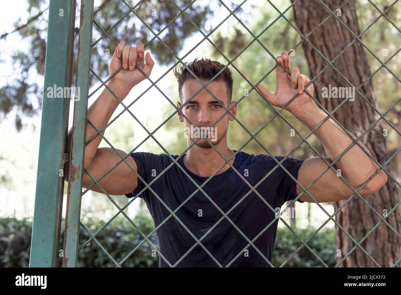 Portrait of a handsome young guy sportsman, wearing sports clothes ...