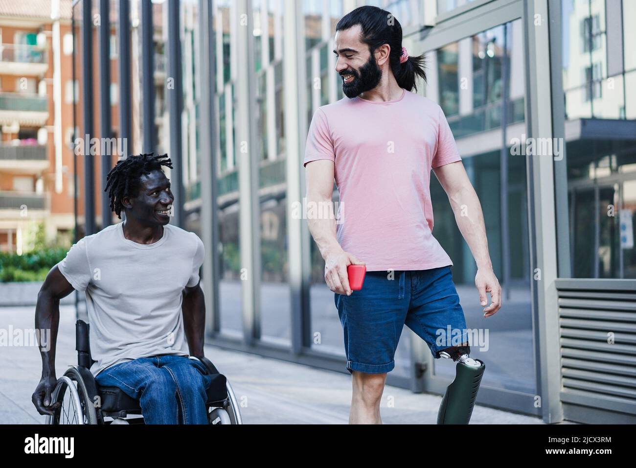 Multiracial friends with disability having fun outdoor - Focus on ...