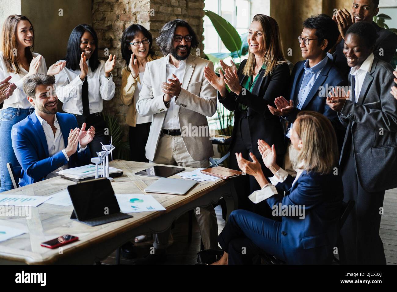 Multiracial business people celebrating together inside modern office ...