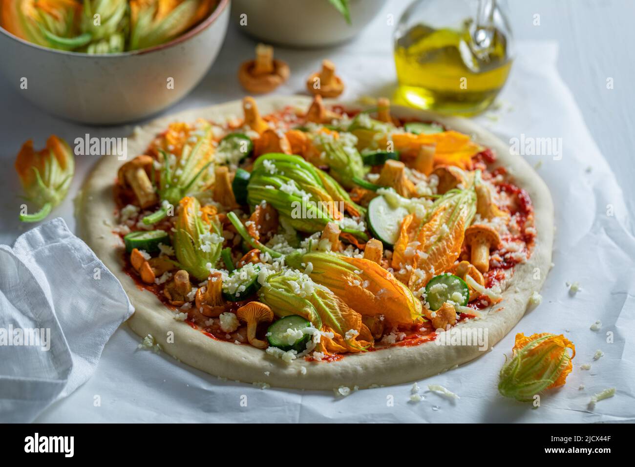 Preparations for homemade pizza made of mushrooms and zucchini flower ...