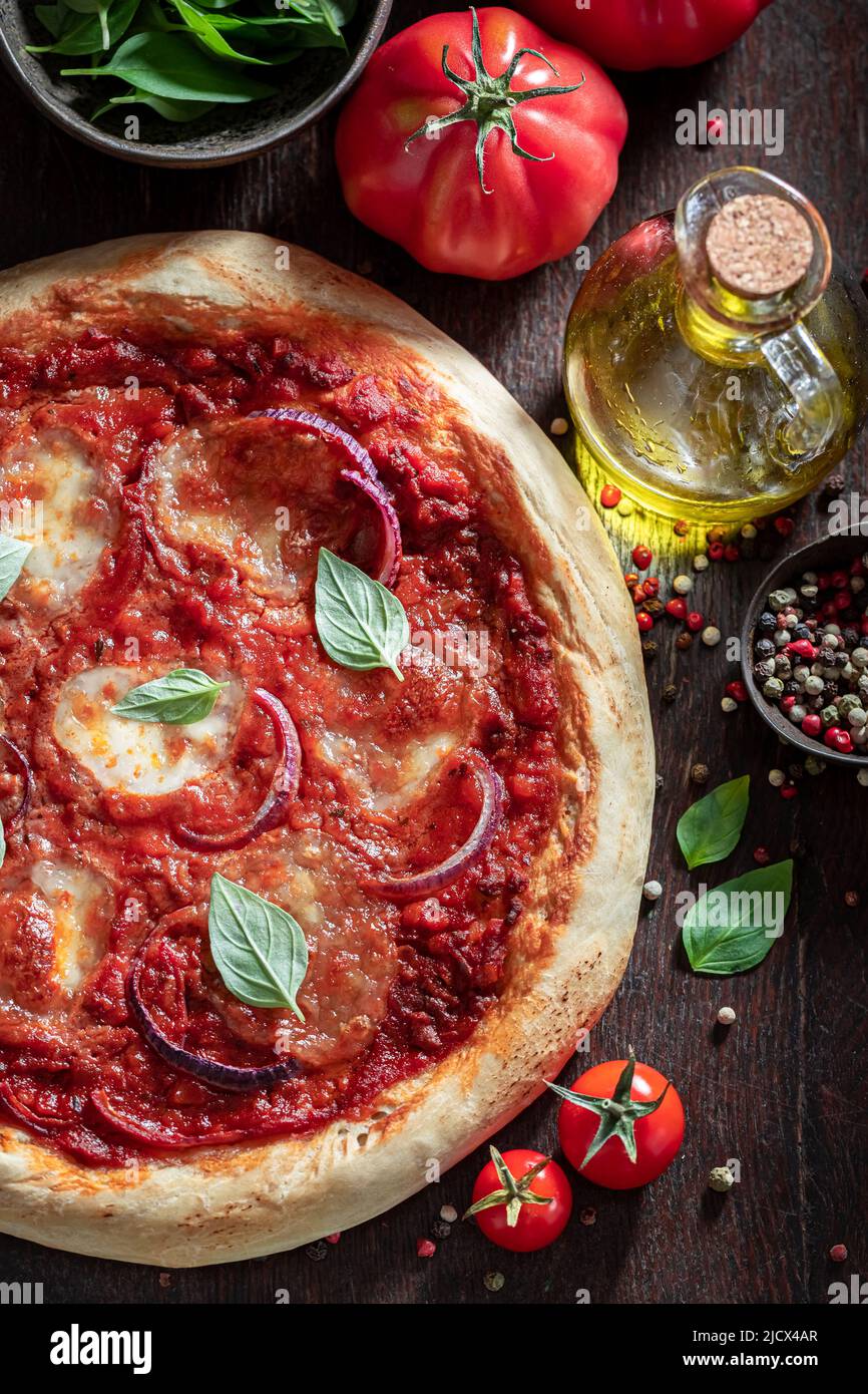 Homemade and hot pizza Pugliese made of tomatoes, meat, onion and basil ...