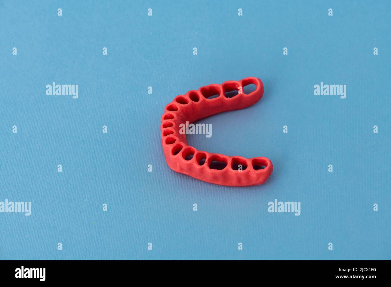 human gums without teeth model medical implant isolated on blue ...