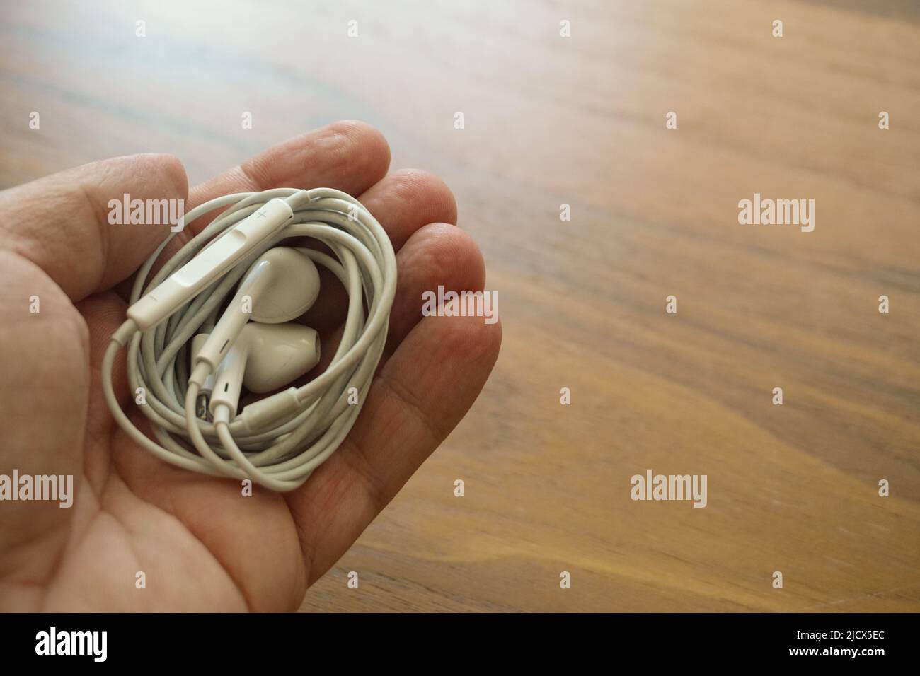 15 August 2021 Eskisehir Turkey. Apple cable headphones in man's hand ...
