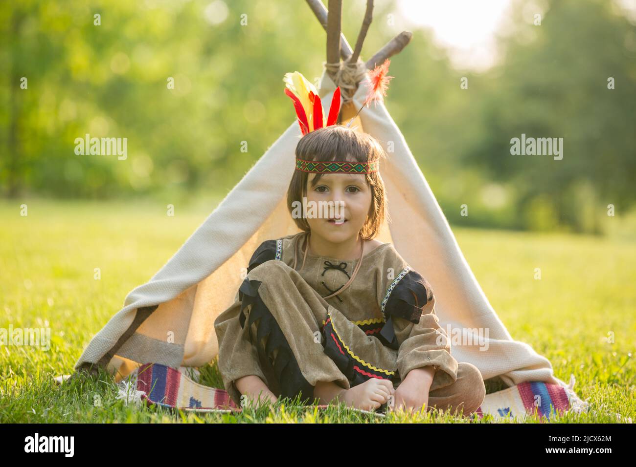 Cute portrait of native american boys with costumes, playing outdoor in ...