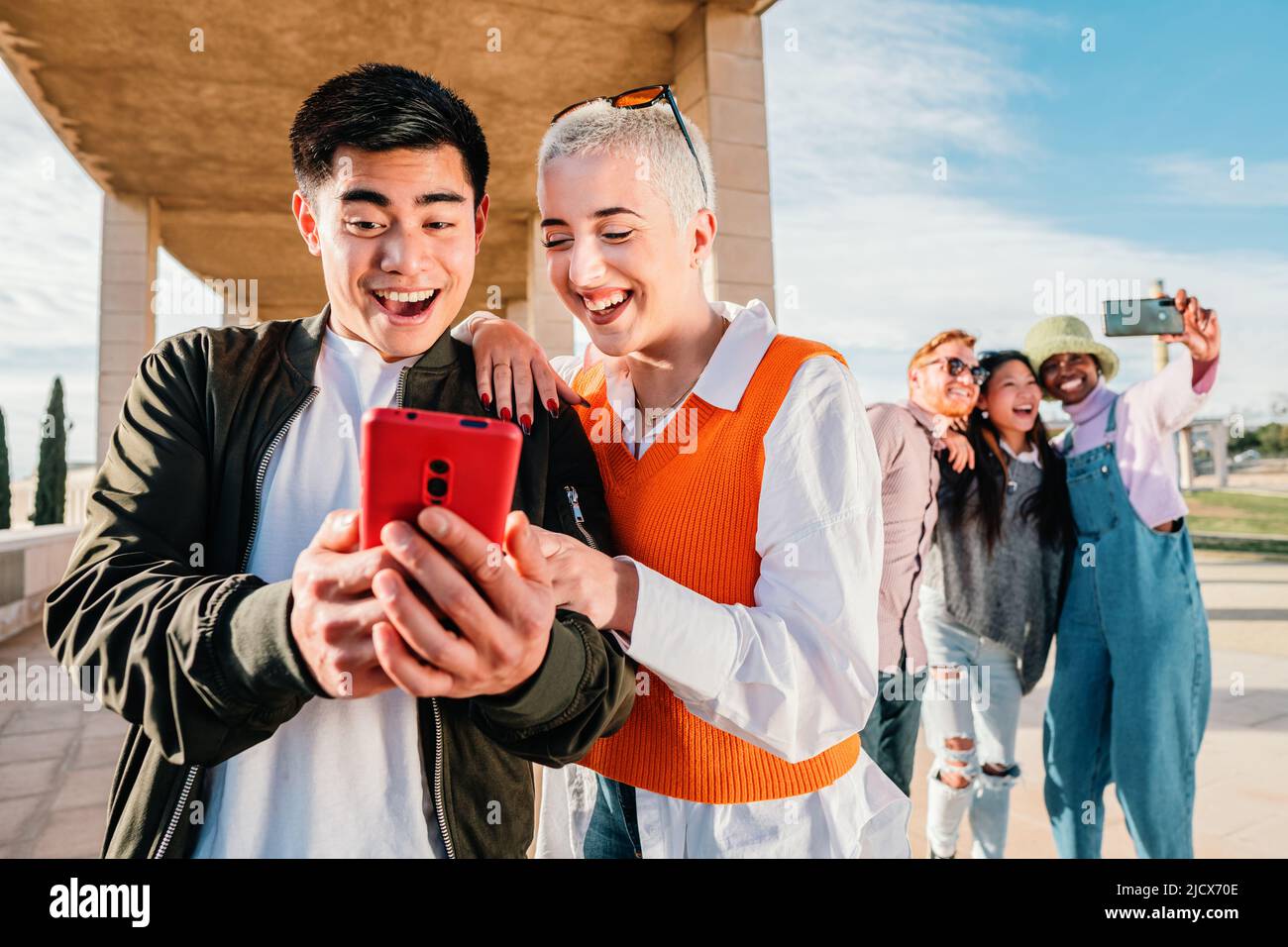 Couple or friends watching and having fun with a smart phone Stock ...
