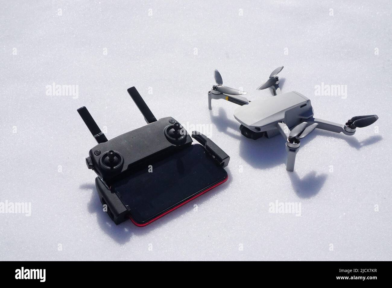 Drone and controller on snow close up view Stock Photo - Alamy