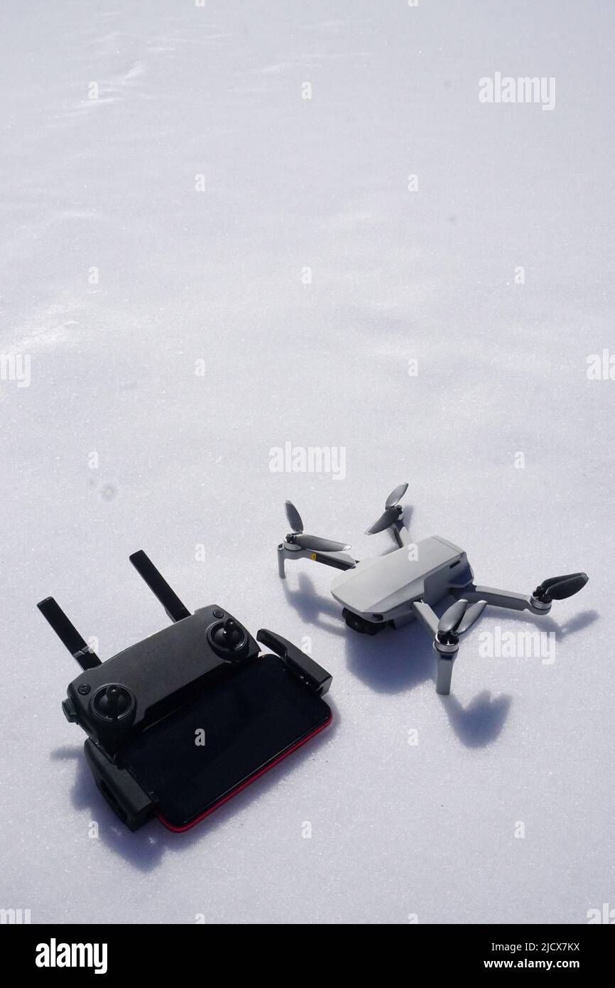 Drone and controller on snow close up view Stock Photo - Alamy