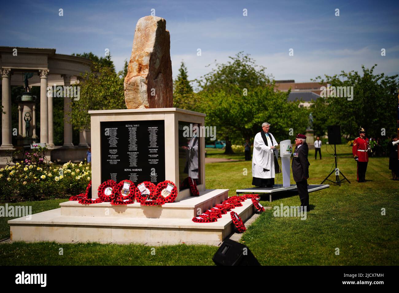 A veteran salutes at a ceremony at the Welsh National Falklands ...