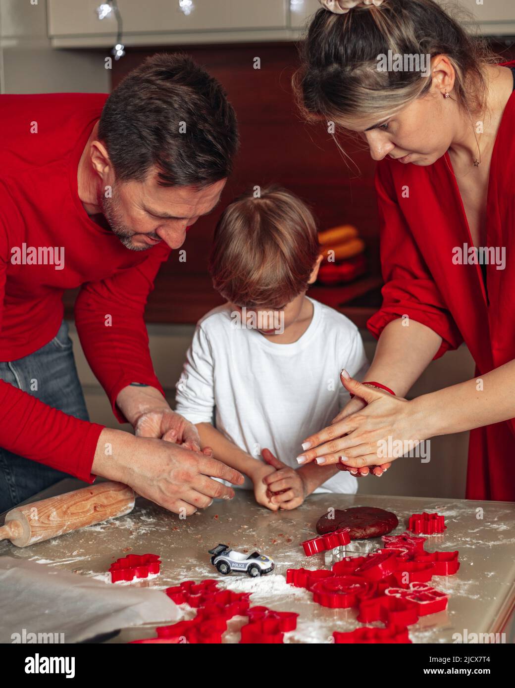 Vertical family photo. Dad, mom, child son boy 4 years bake cookies ...