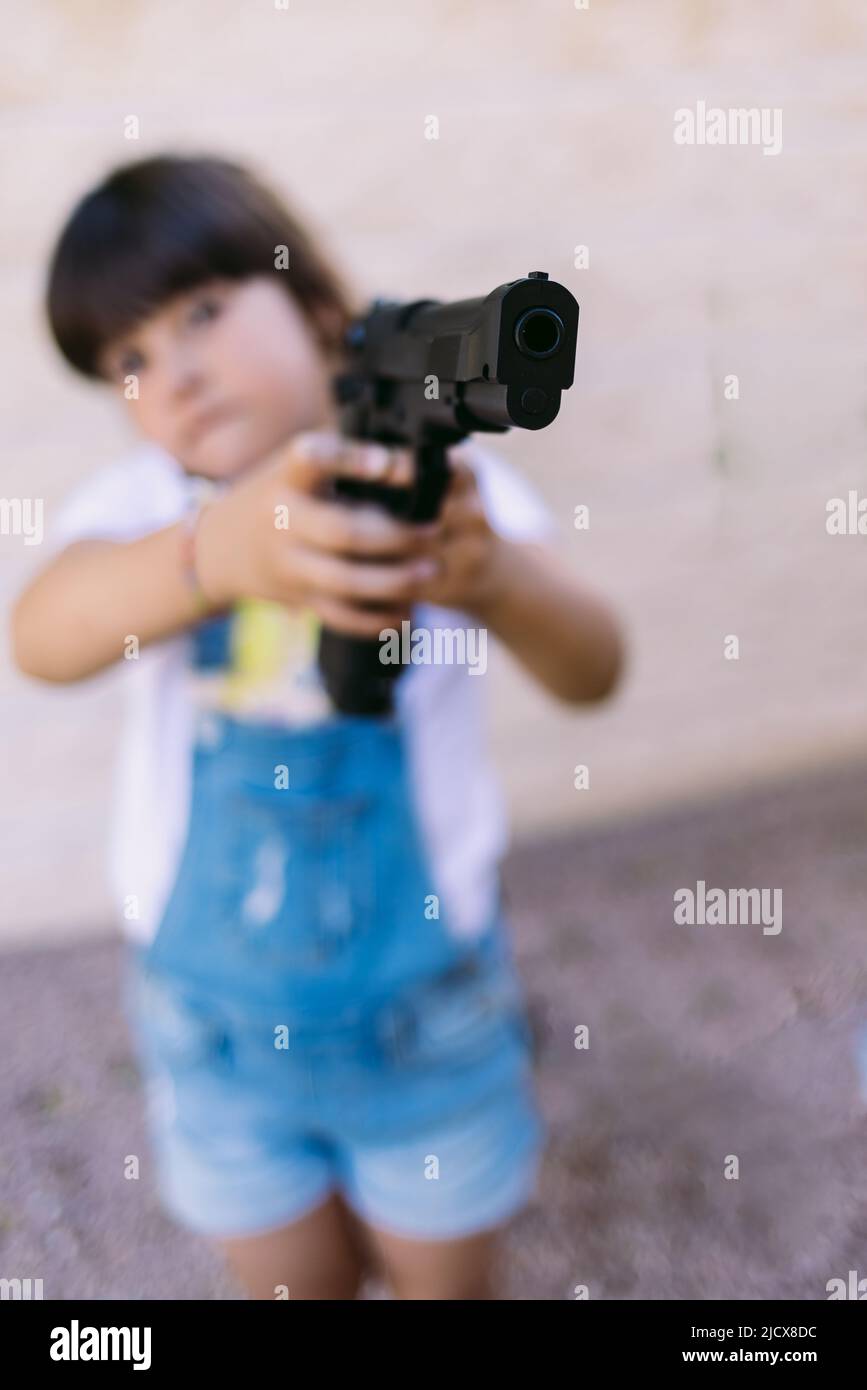 Little girl pointing a gun. Concept of violence, weapons, guns ...