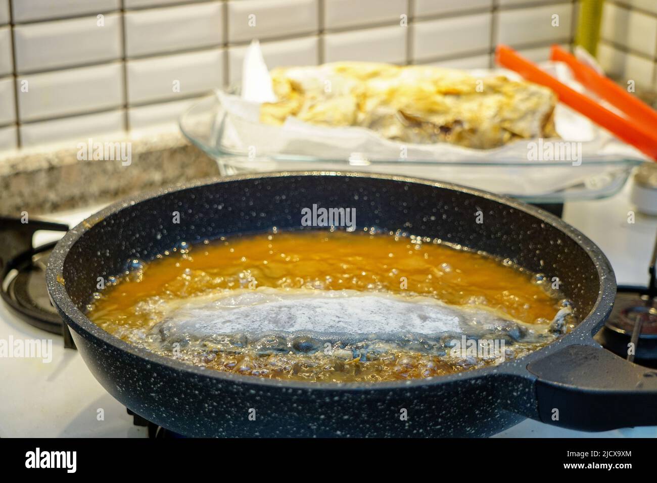 Oil Roasted bonito fish preparation in the kitchen on the oven candid ...