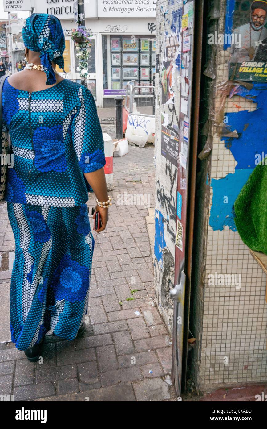 Afro caribbean woman wearing a traditional blue dress in Peckham High ...