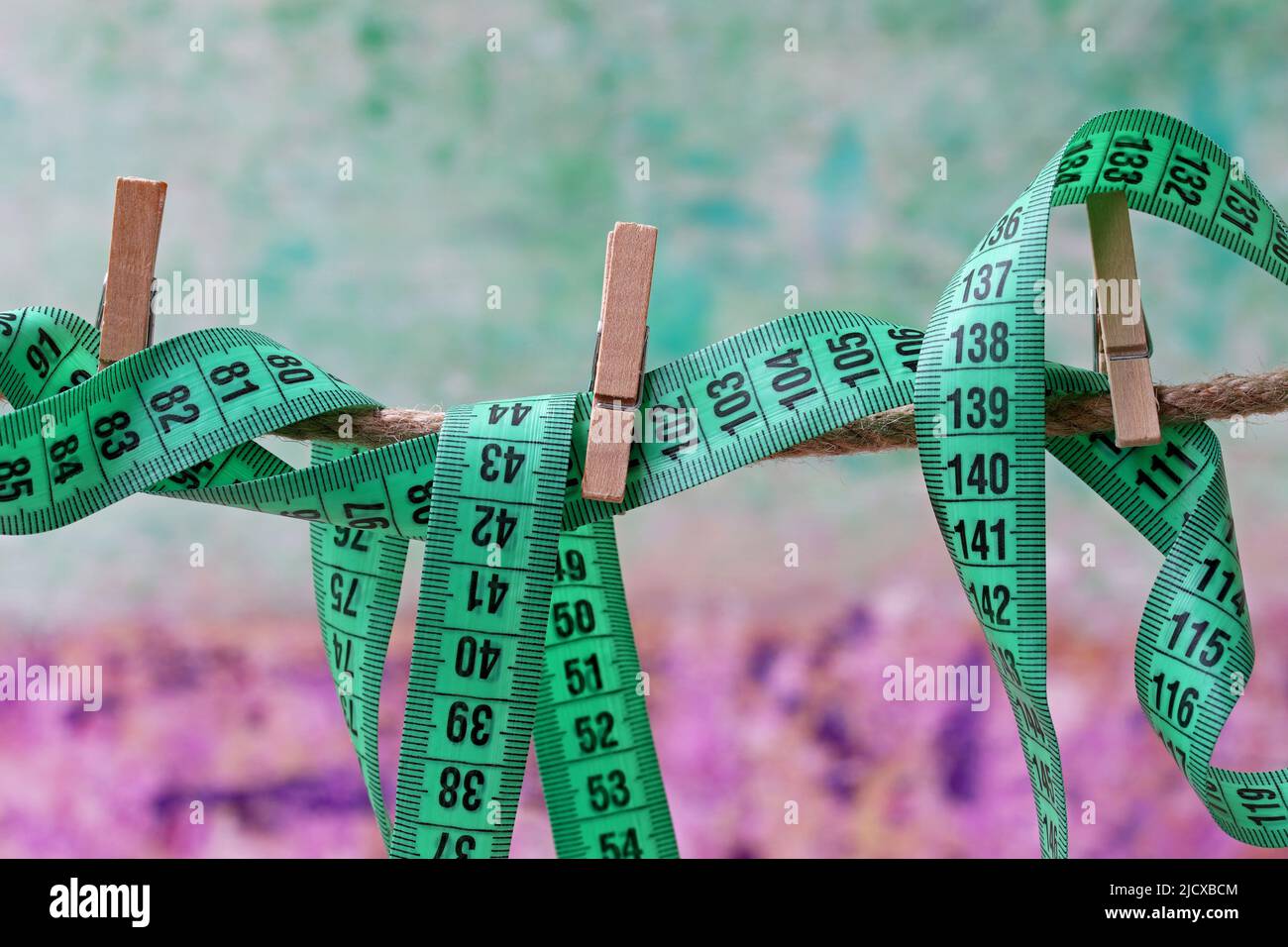 Colorful measure tape hanging on clothesline Stock Photo - Alamy