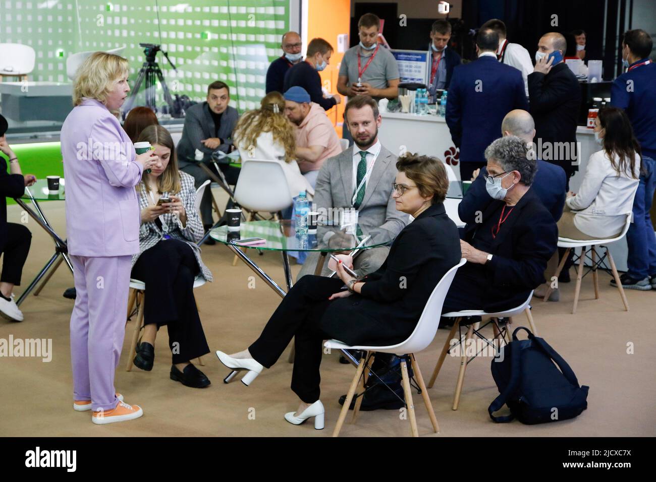 People relax over a cup of coffee in a cafe on the St. Petersburg ...
