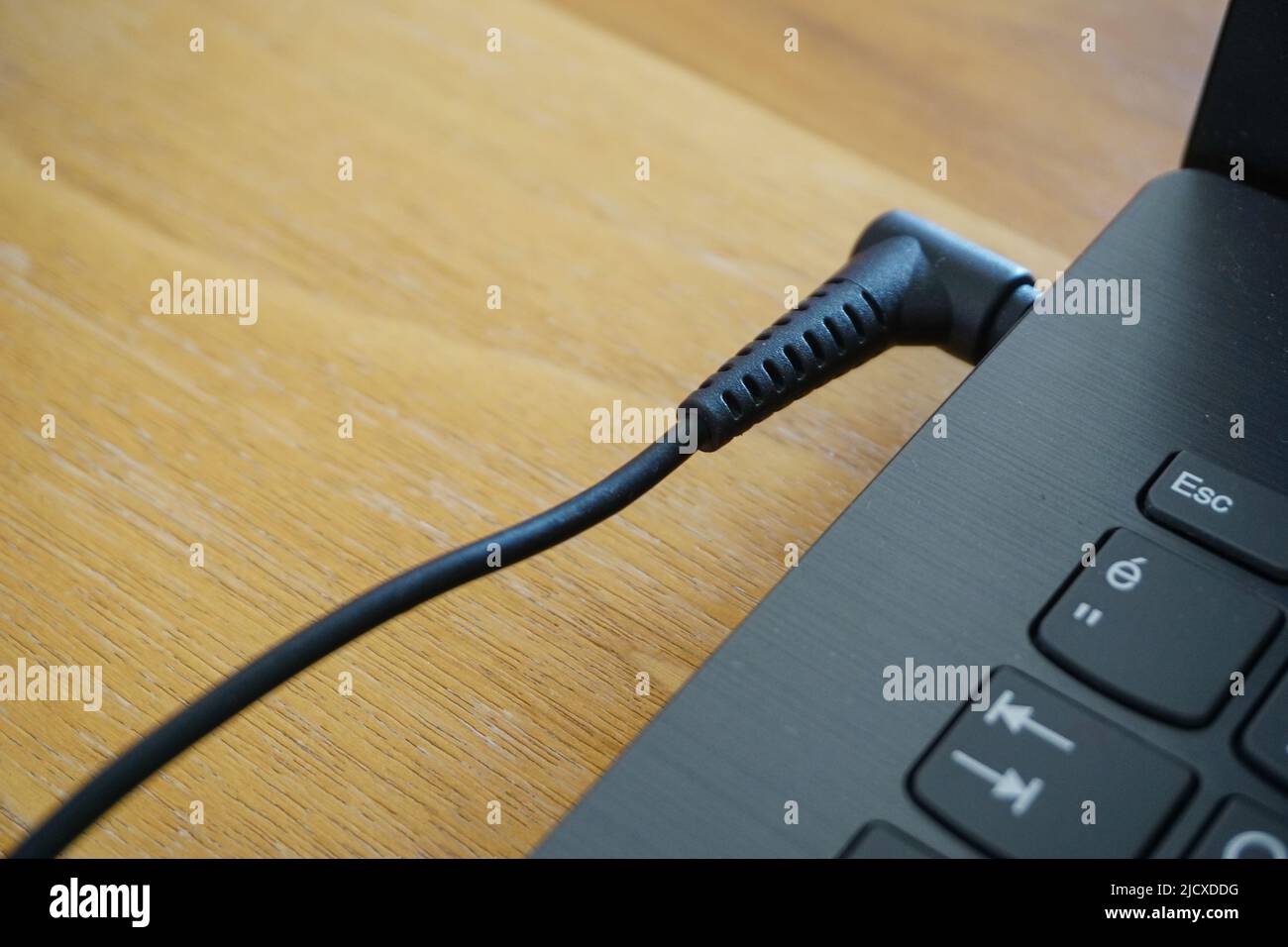 Laptop charge socket plugged in close up view Stock Photo - Alamy