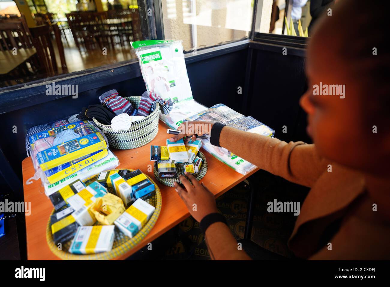 A member of staff arranges cigarettes for sale in the gift shop at the ...