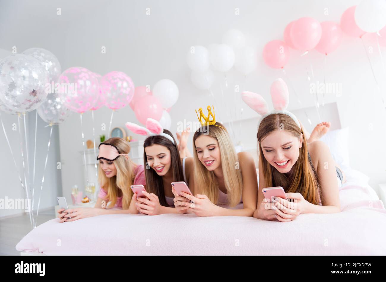 Photo of cute pretty young ladies nightwear headbands typing modern ...