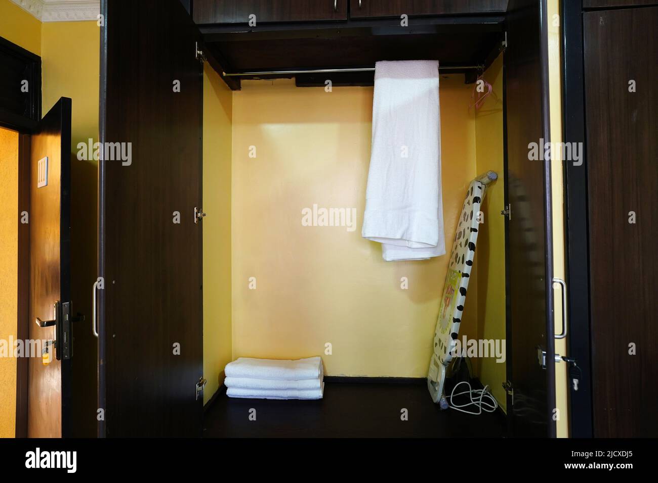 An ironing board and towels in a bedroom at the Hope Hostel in Kigali ...