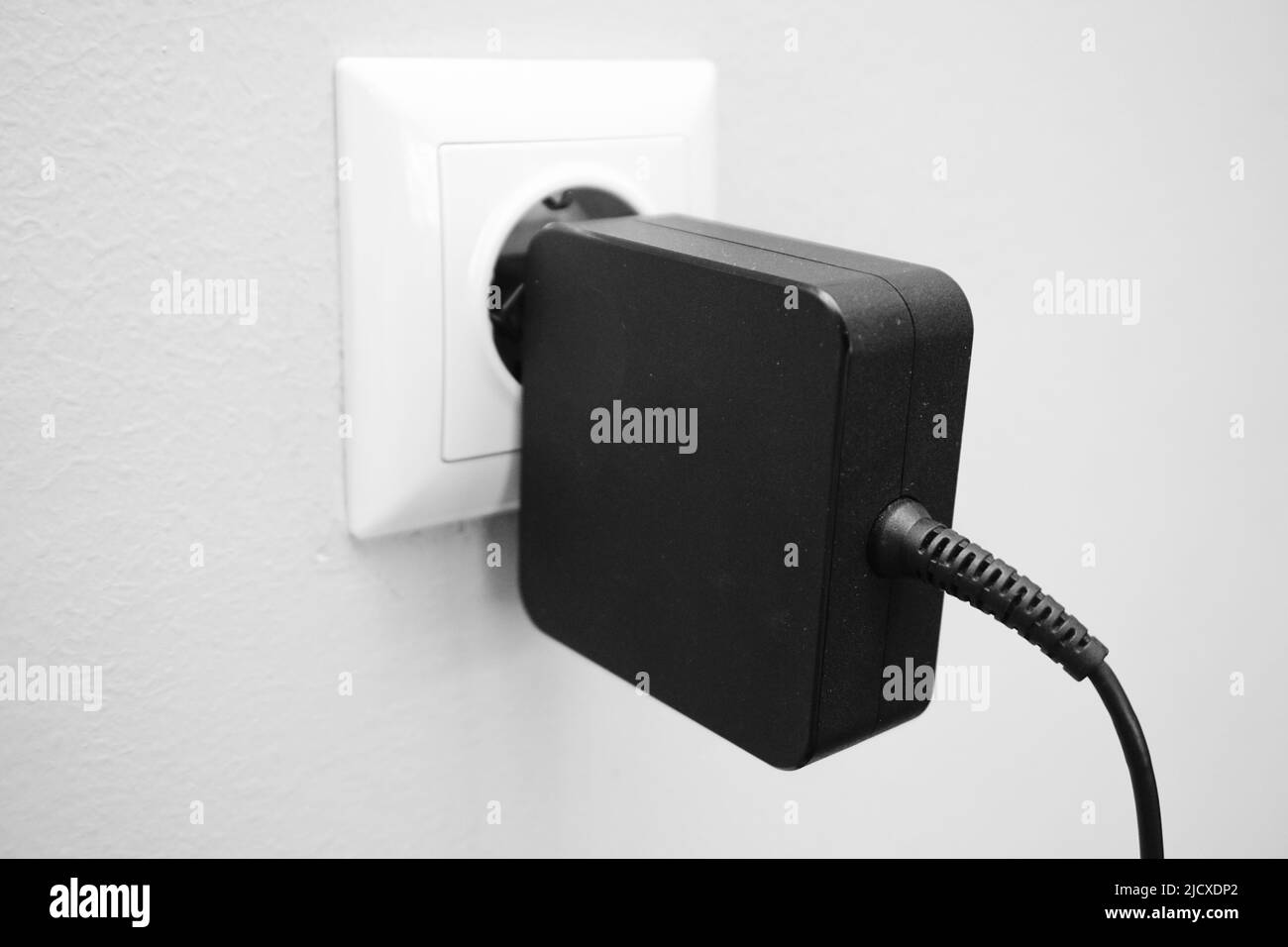 Charger adaptor plugged in close up view Stock Photo - Alamy