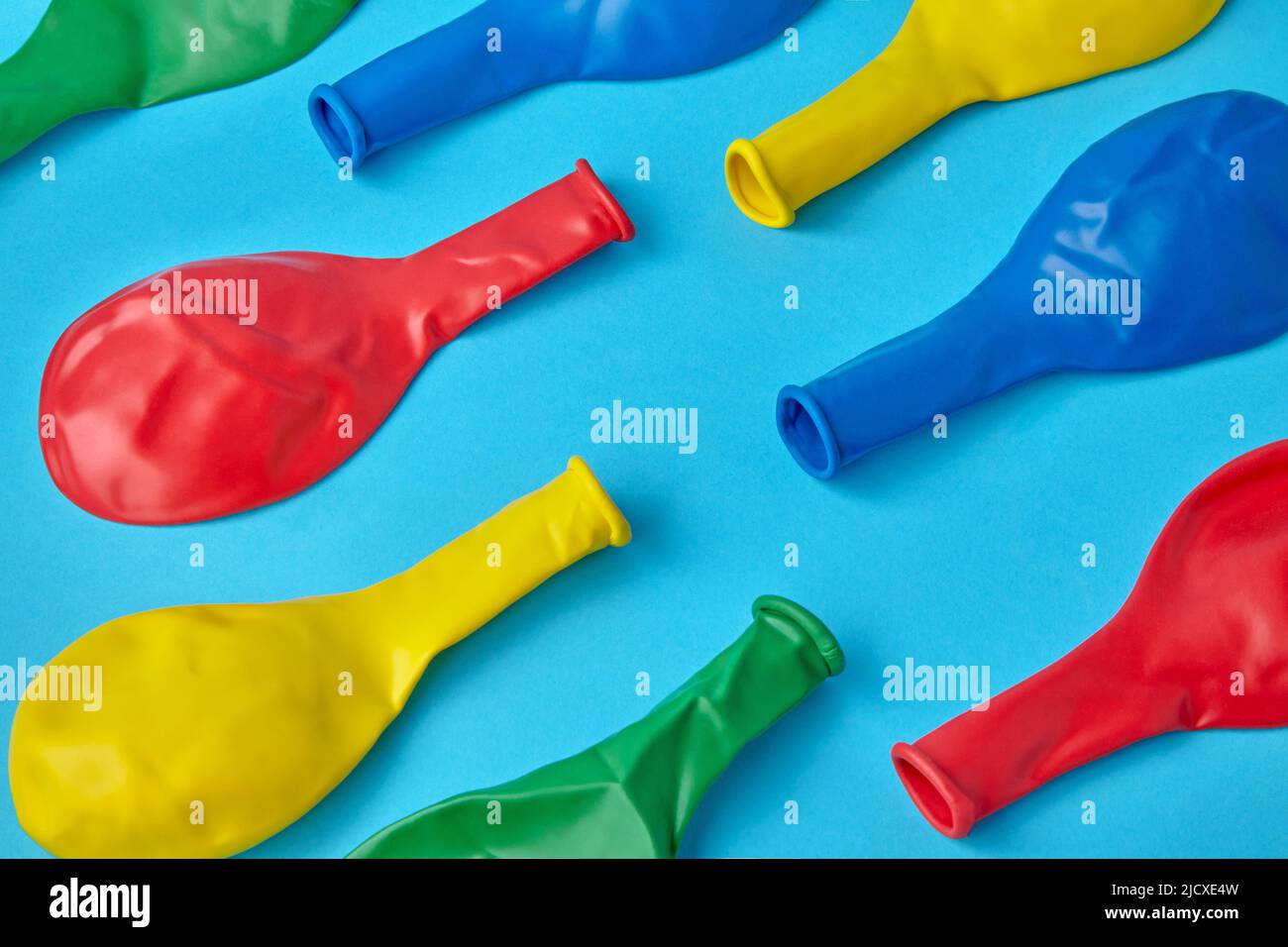 Multi-colored not inflated balloons red, yellow, blue, green lie ...