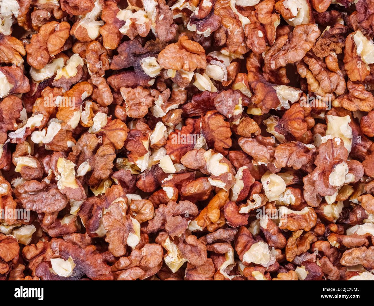 Top view of pile of peeled crushed walnuts as background Stock Photo ...