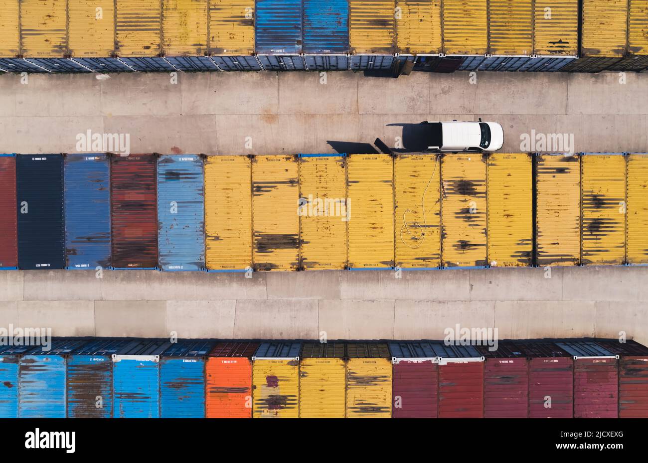 Aerial outdoor view of red, orange, blue and yellow rusty containers ...