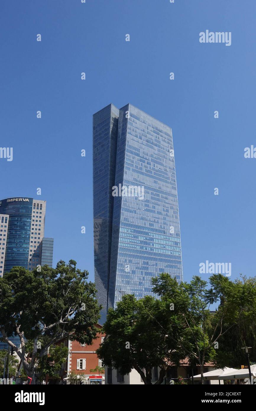 Very tall skyscraper in sun beams on background Stock Photo - Alamy