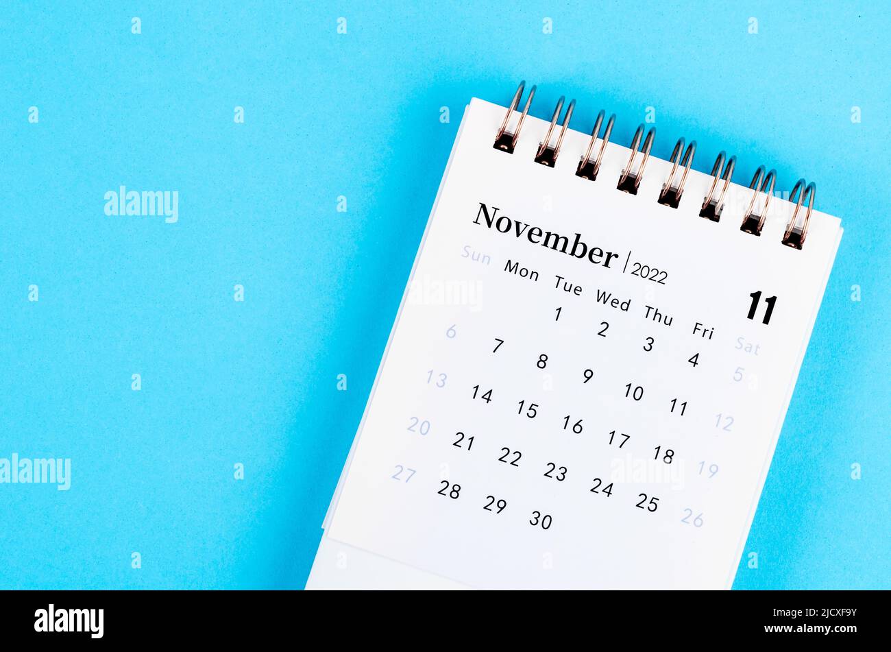 The mini November 2022 desk calendar on blue background Stock Photo - Alamy
