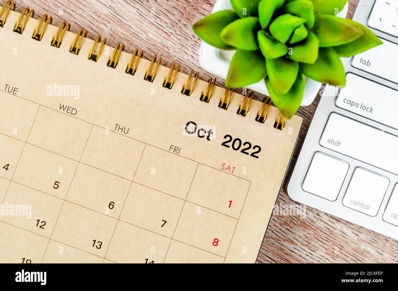 The October 2022 desk calendar with keyboard computer on wooden ...