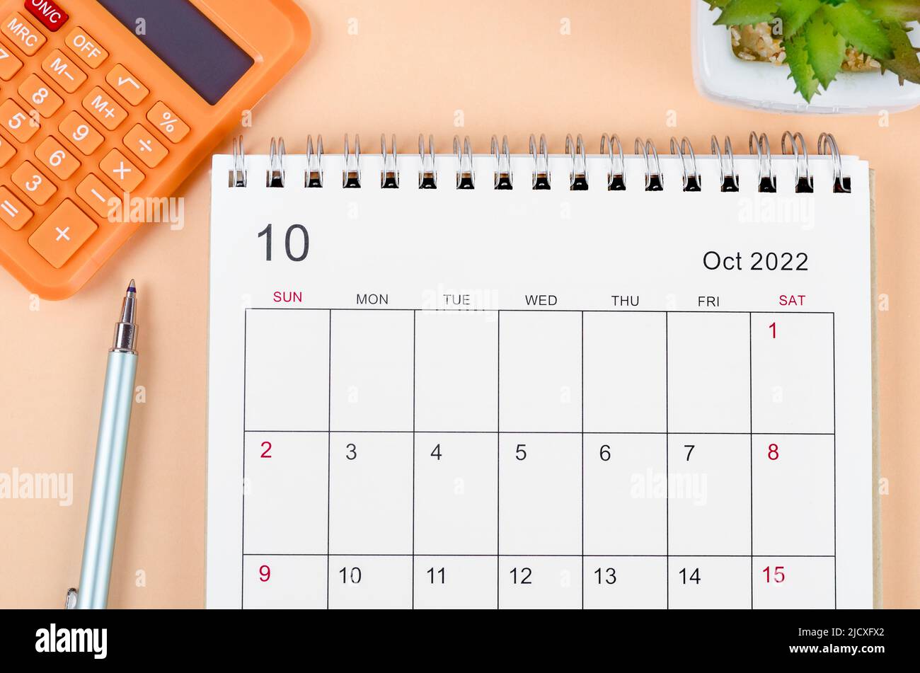 The October 2022 desk calendar with calculator on beautiful background ...