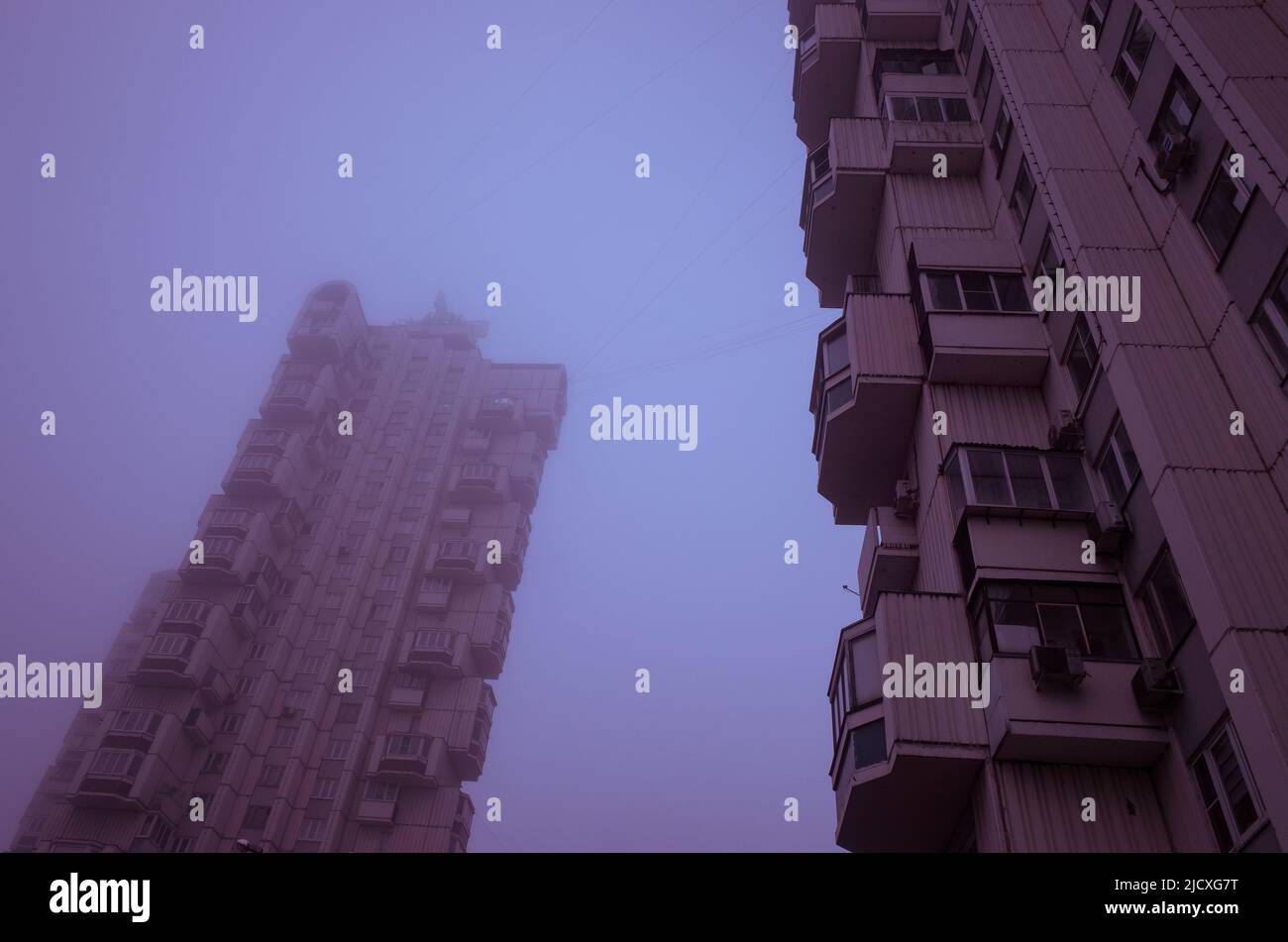 Two tall residential buildings in the form of a tower, immersed in a ...