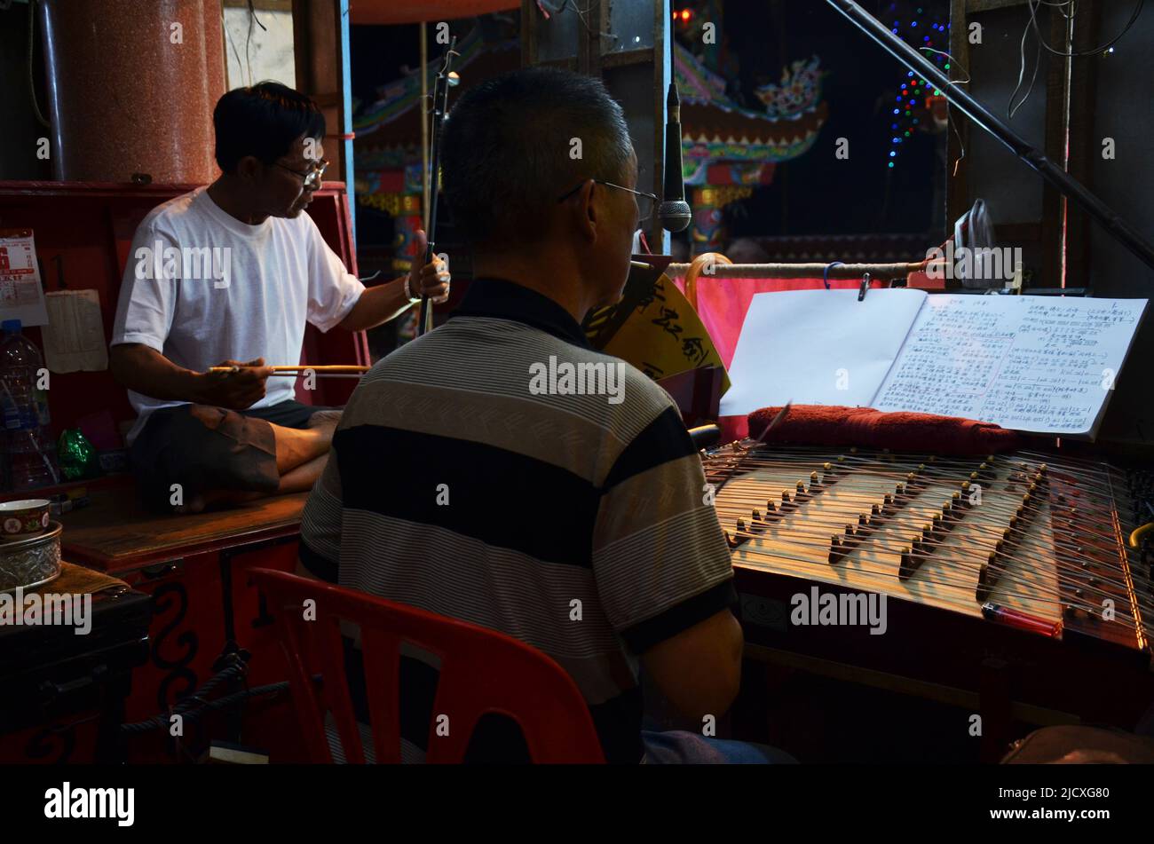 Thai people of chinese descent playing musical instruments sing song ...