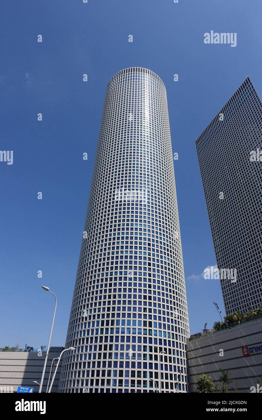 Very tall round skyscraper in sun beams Stock Photo - Alamy
