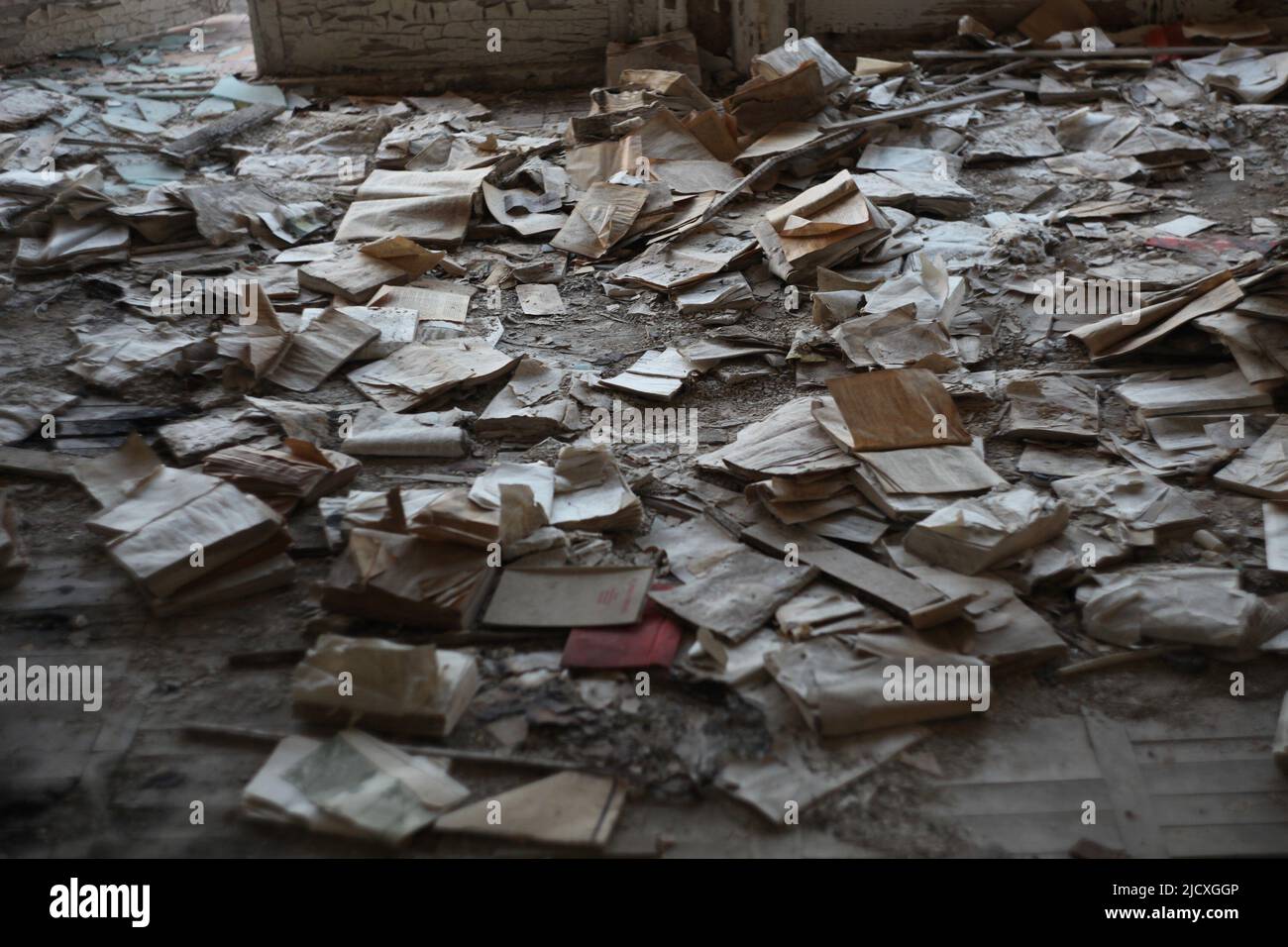 Pile of books lying on floor in abandoned building Stock Photo - Alamy